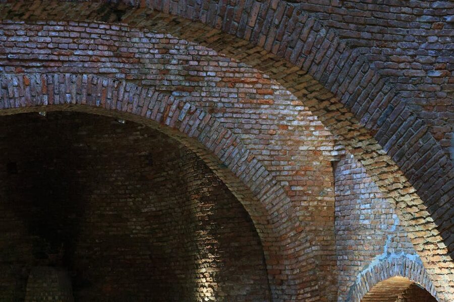 Textured brick archways in historic underground structure
