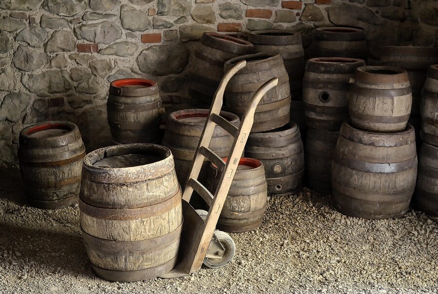 Vintage wooden beer barrels stacked in historic cellar