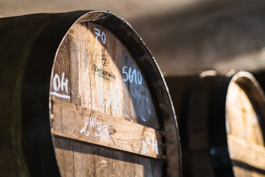 Wooden cognac barrels stacked in a cellar in Cognac France