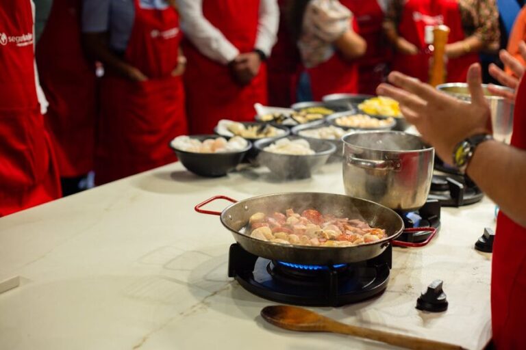 Participants learning cooking skills in a hands-on class setting