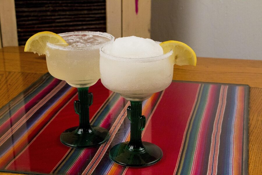 Margaritas with tequila and lime wedges