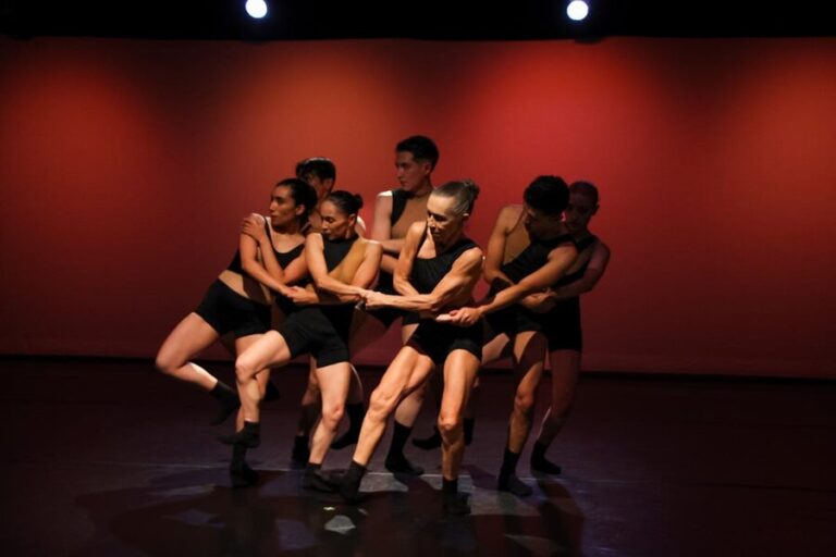 Contemporary dancers performing energetically on stage