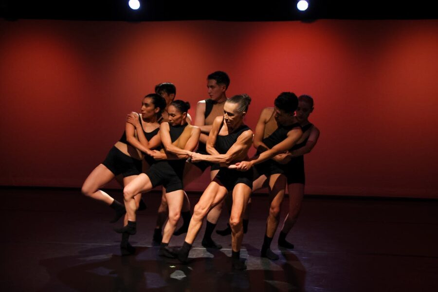 Contemporary dancers performing energetically on stage