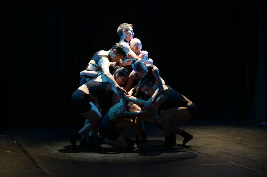 Dancers performing dramatic piece on theater stage