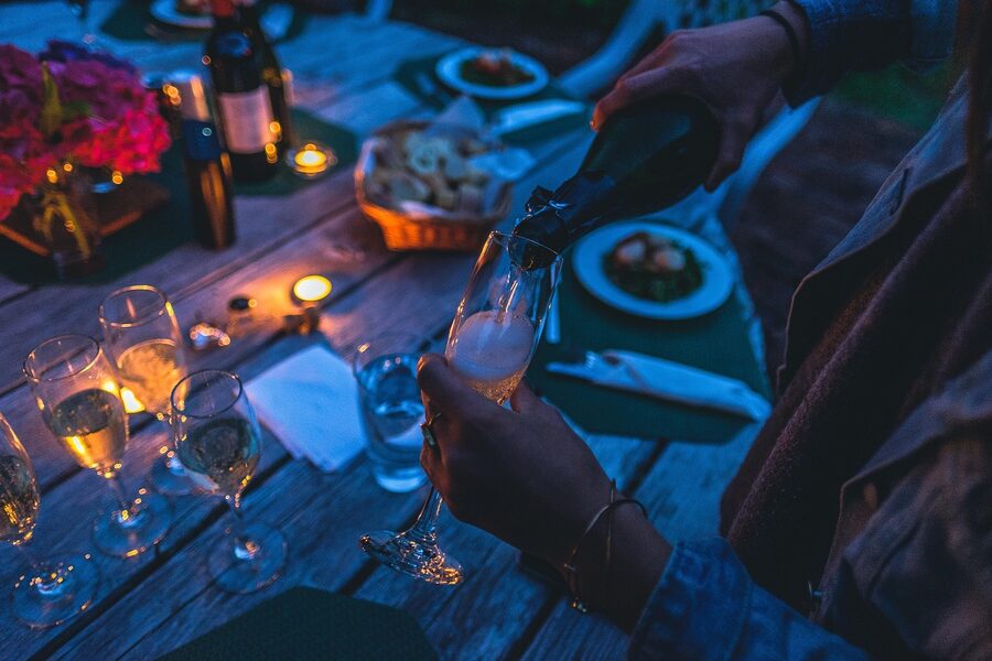 Champagne pour at evening table before Crazy Horse Paris