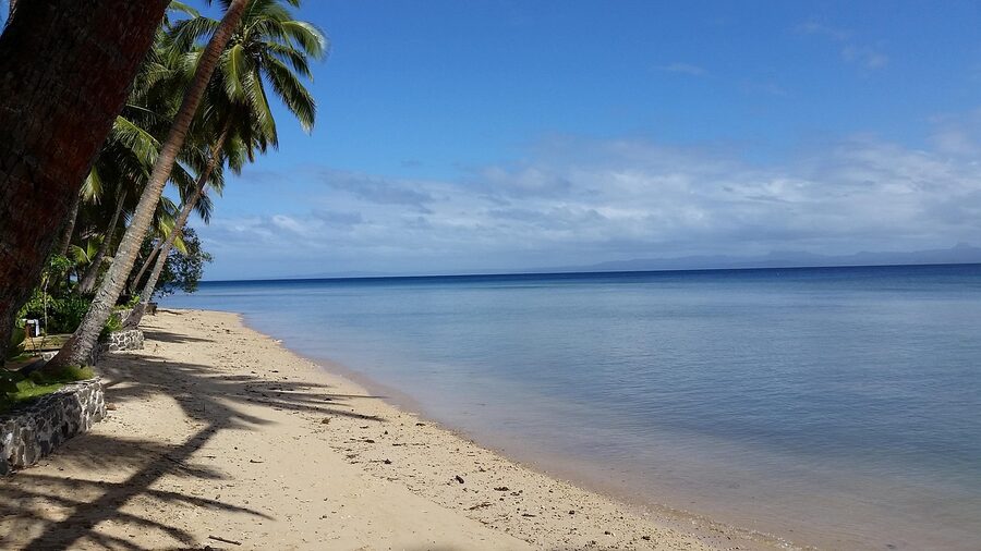 An idyllic Fijian beach with calm sea