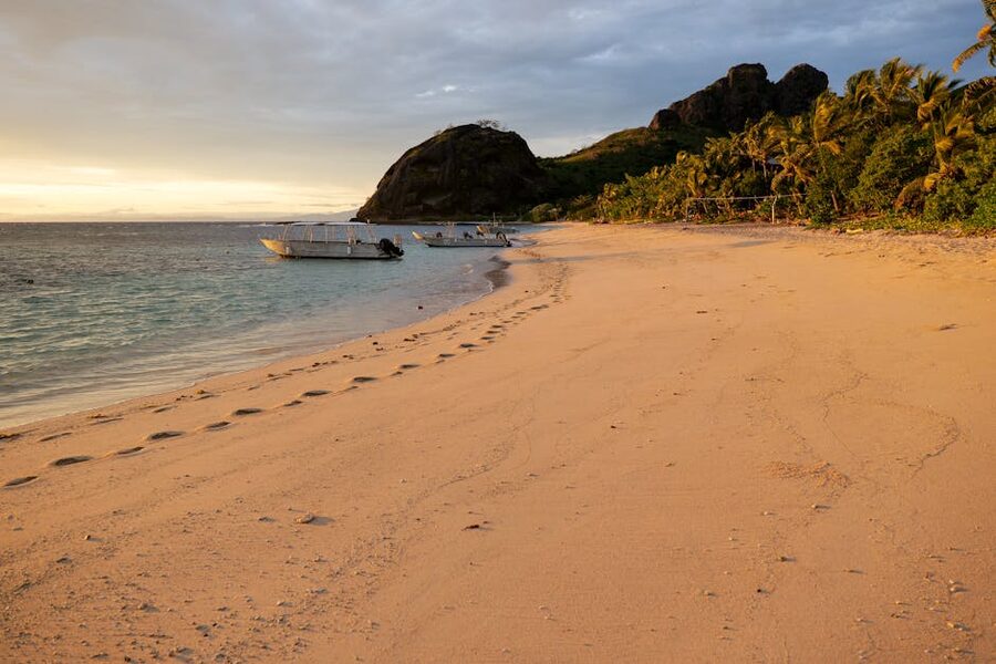 Beach scene with boats and palms in the Yasawa Islands area, Fiji