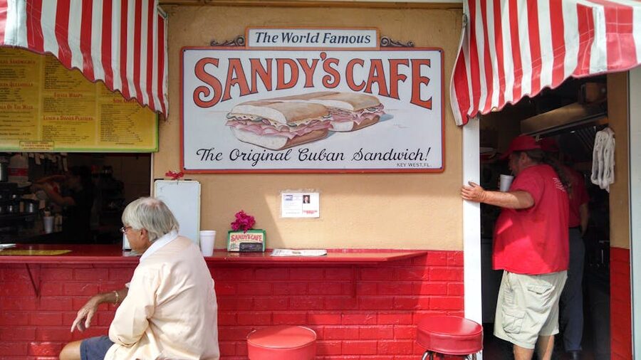 A Cuban sandwich cafe with customers at a bright counter
