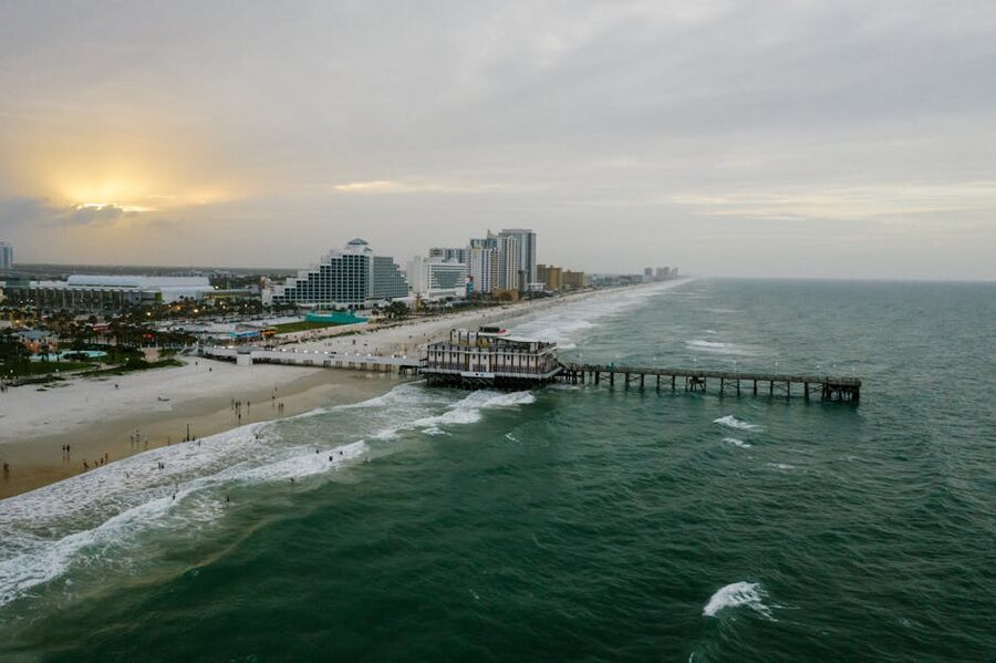 Aerial view of Daytona Beach pier and coastline at sunset