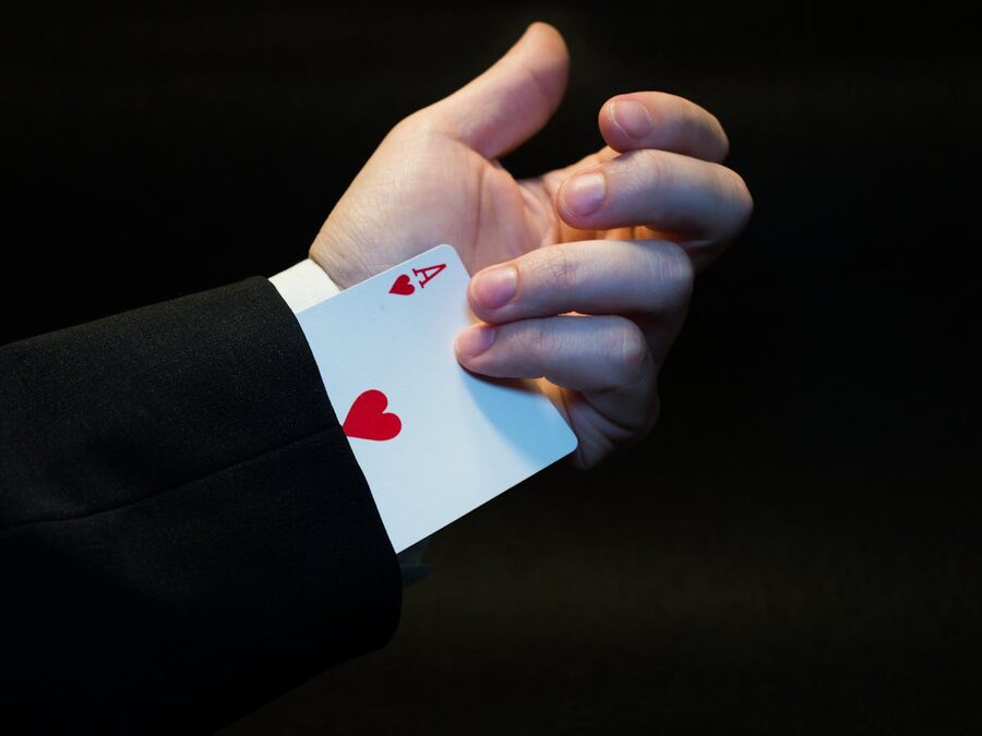 Magician hand showing ace hidden up sleeve