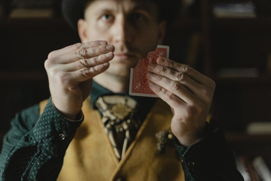 Close-up of hands performing card trick