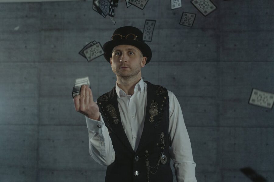 Magician in steampunk style performing card trick