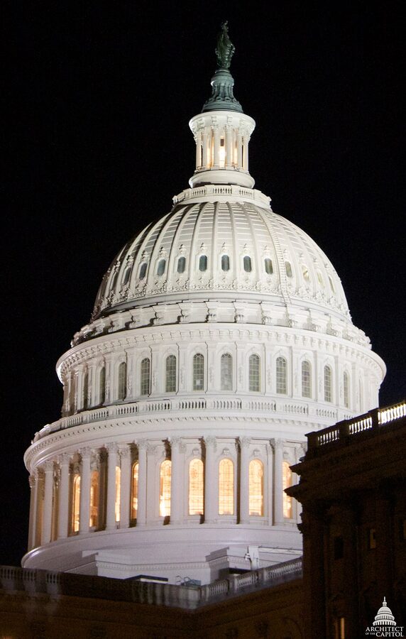 US Capitol dome lit against a dark night sky