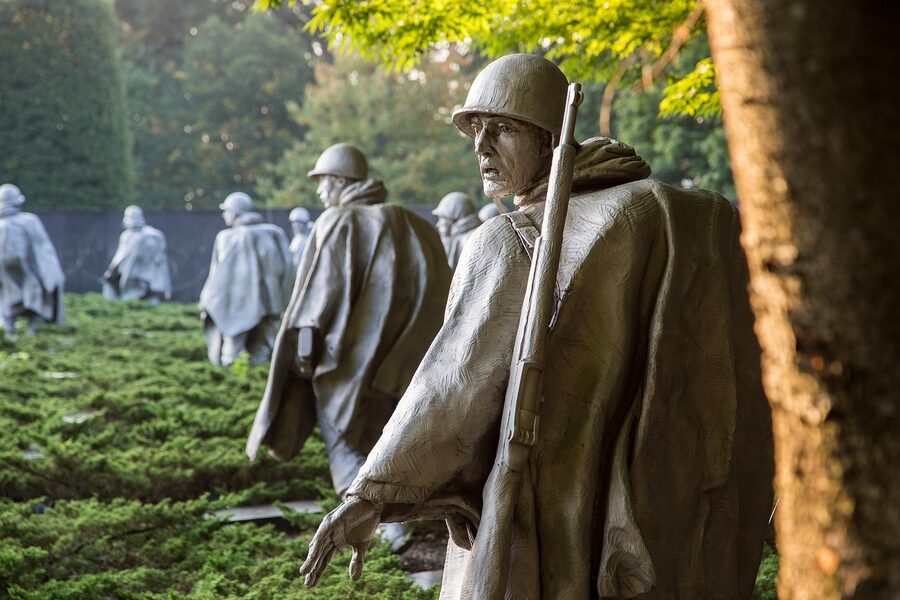 Korean War Memorial statues in rain at night