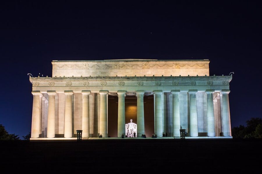 Lincoln Memorial illuminated at night across the Reflecting Pool in Washington DC
