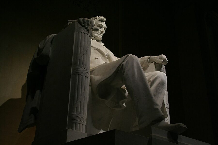 Seated Abraham Lincoln statue at night inside the Lincoln Memorial