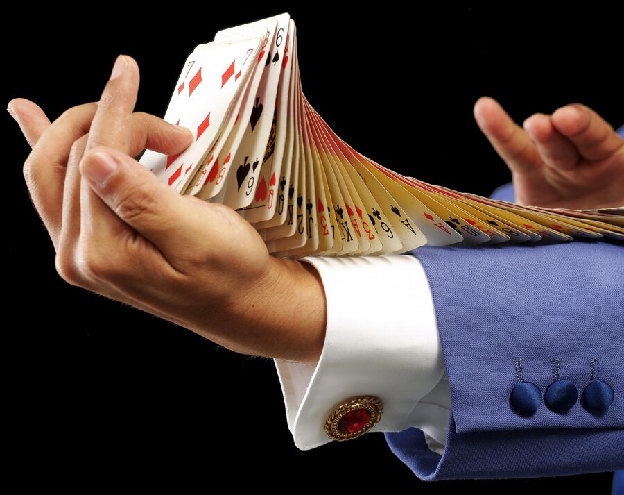 Magician performing card flourish magic trick