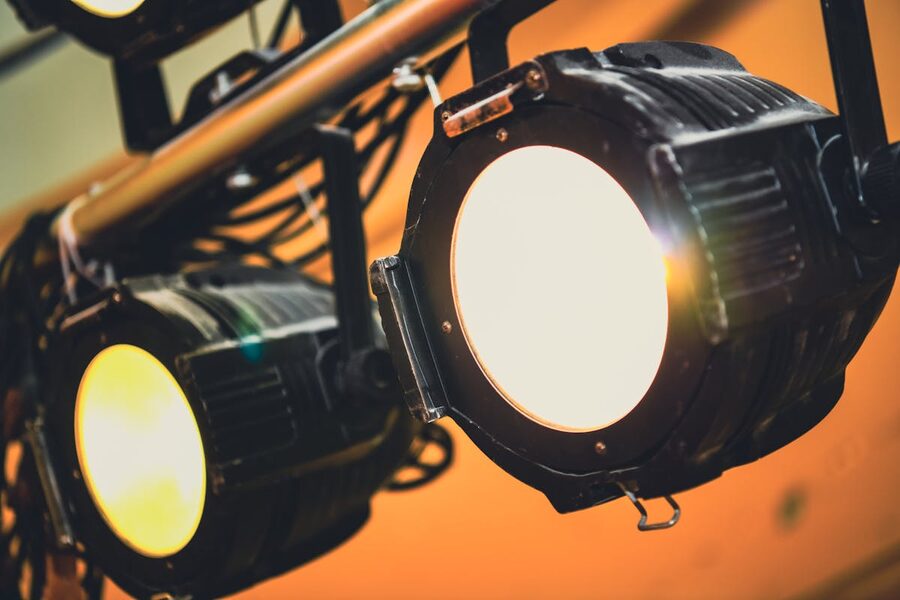 Stage spotlights casting warm light theater