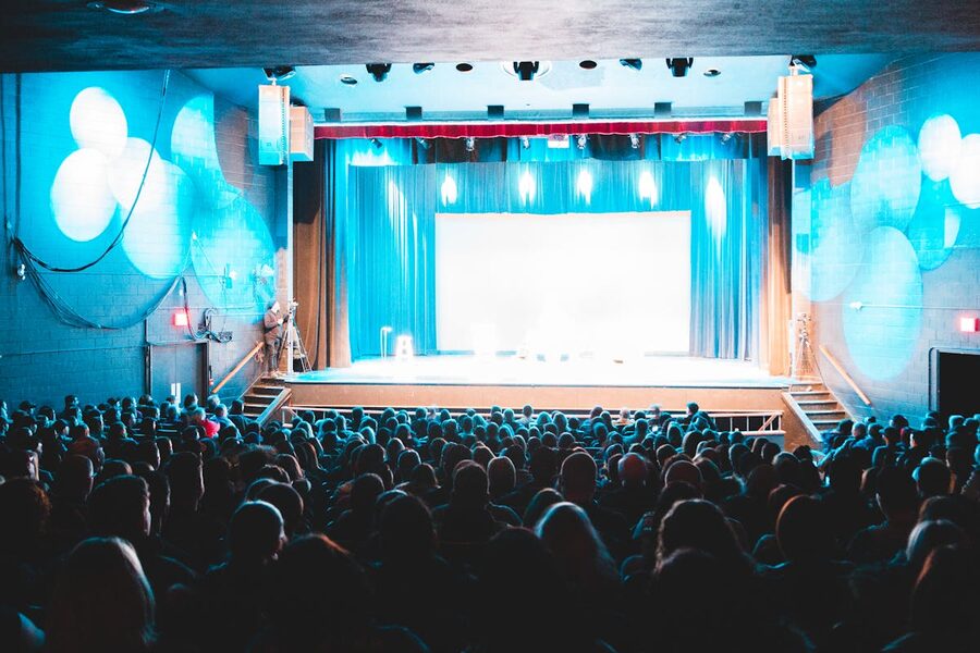 Theater scene with captivated audience under bright lights