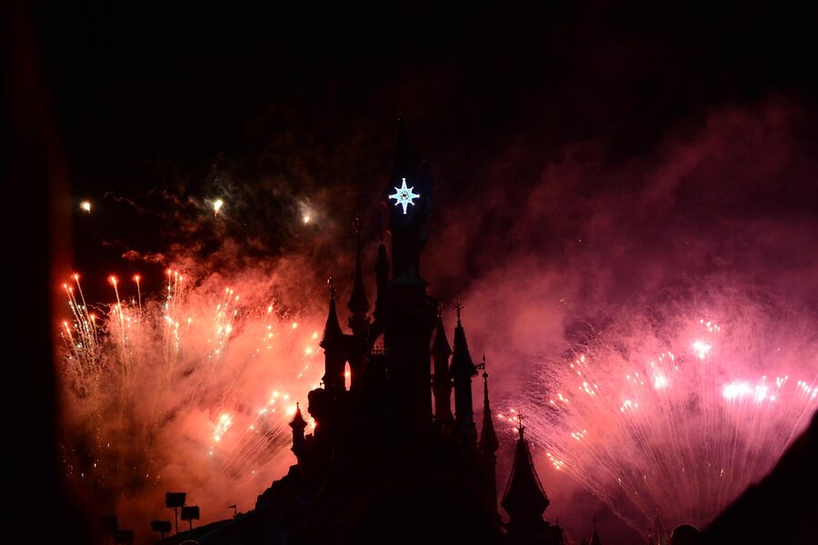 Disneyland Paris castle with pink fireworks at night