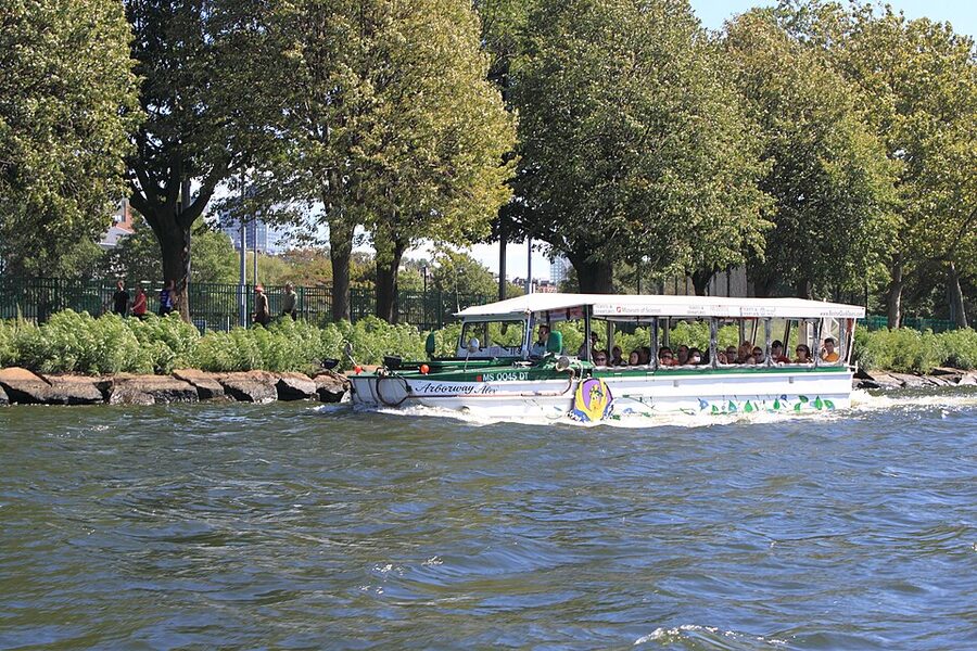 Duck boat cruising the Charles River with Cambridge shore visible