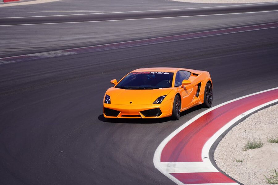 Orange sports car racing on track in Las Vegas