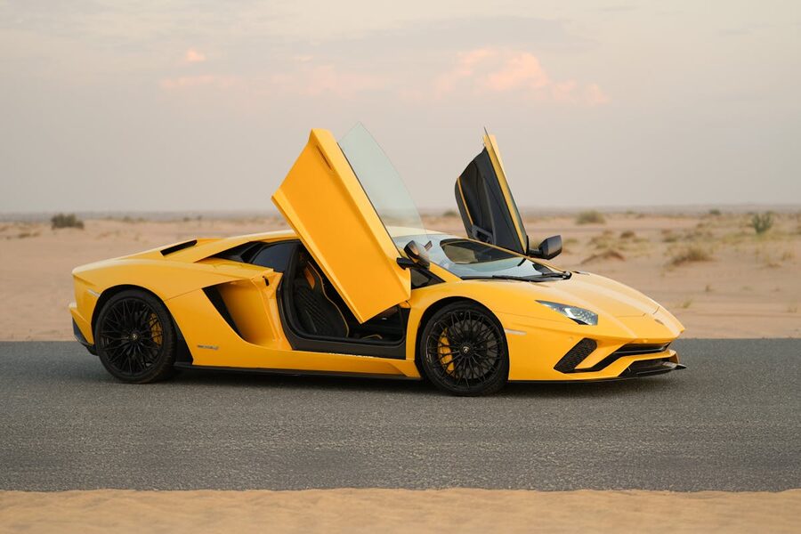 Yellow Lamborghini Aventador on desert road with open sky