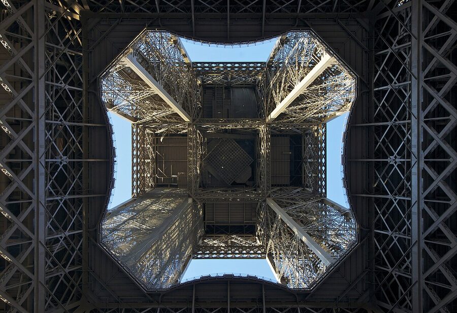 Looking up beneath the Eiffel Tower iron lattice