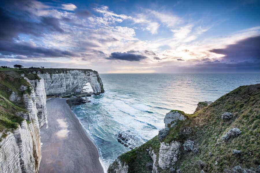 Etretat cliff and pebble beach at sunset Normandy