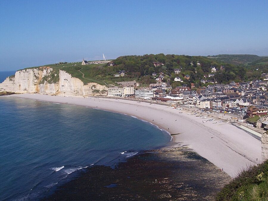 View of Etretat town and pebble beach from the Falaise dAval