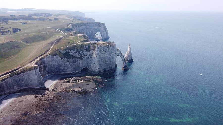 Aerial of Falaise dAval arch and Aiguille rock at Etretat