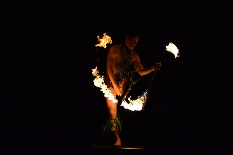 Fire dancer performing a traditional Hawaiian dance at night