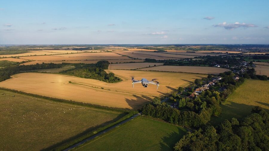 Aerial view of drone flying over lush farmlands