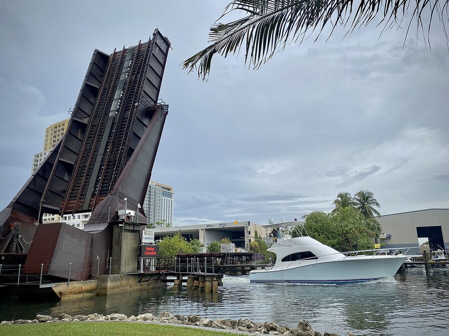 Rail drawbridge over the New River in Fort Lauderdale with a boat passing through