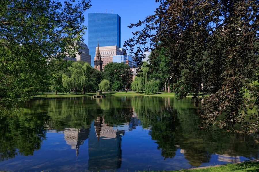 Boston skyline reflected in Public Garden pond on the Freedom Trail