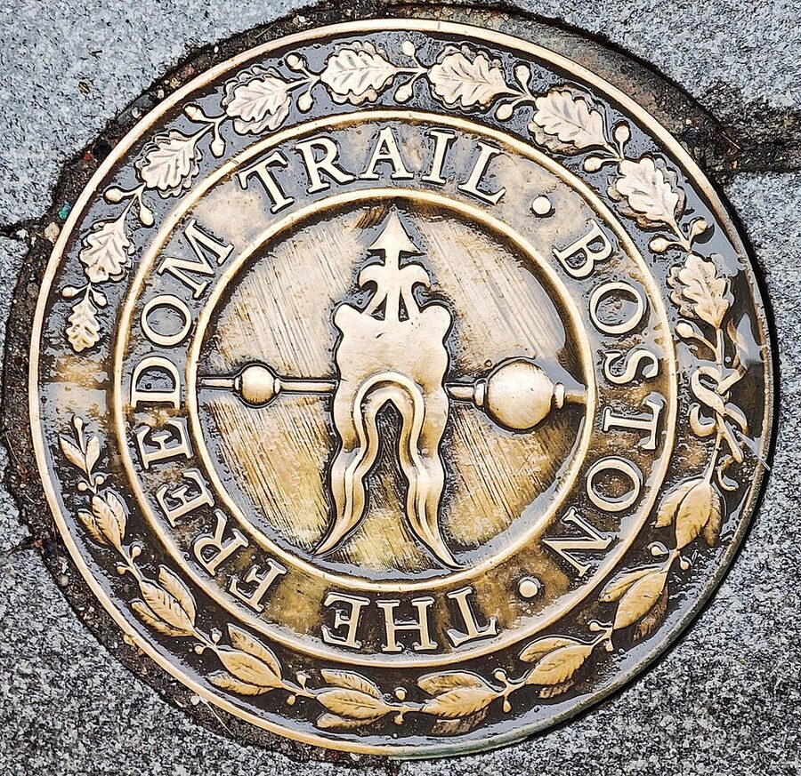 Brass Freedom Trail marker set into a Boston sidewalk