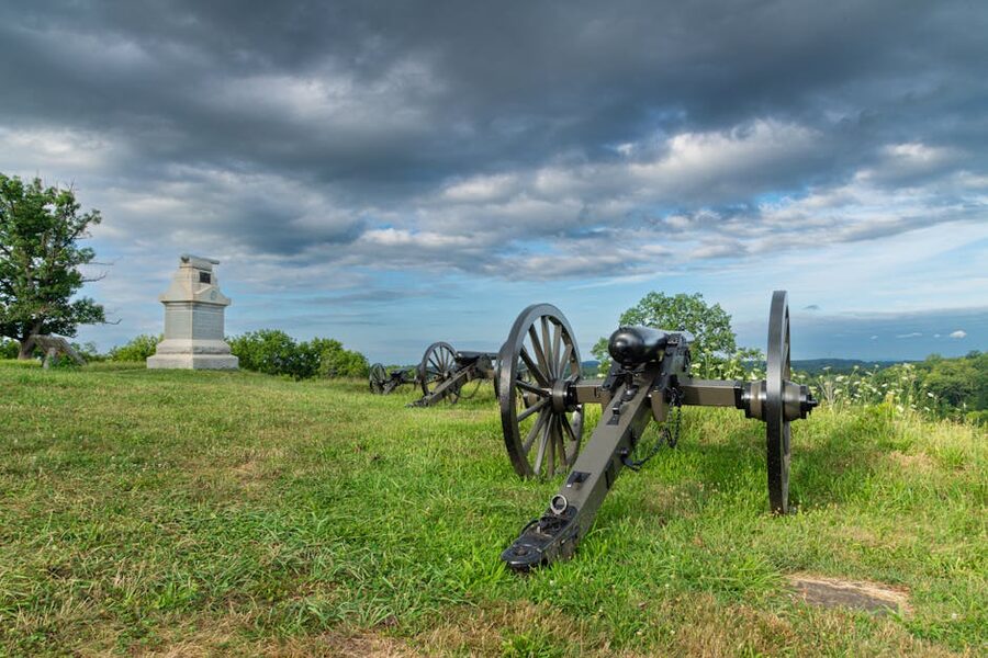 Gettysburg battlefield cannons under dramatic sky