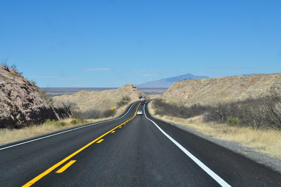 Desert highway in Arizona stretching toward distant mountains