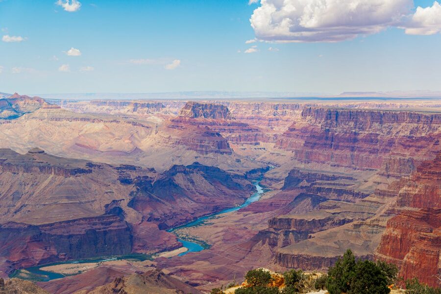 Panorama of Grand Canyon with Colorado River under blue sky