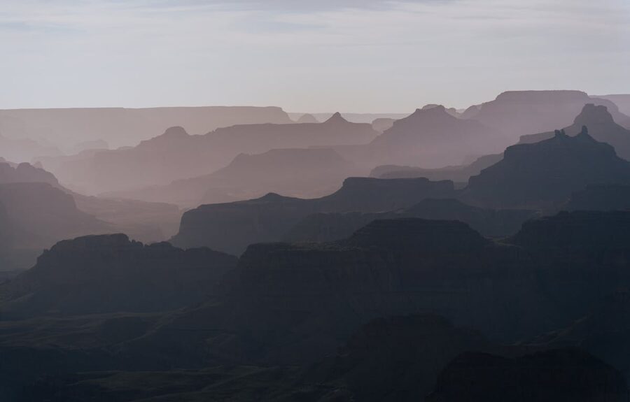 Grand Canyon South Rim at sunset with hazy layered cliffs