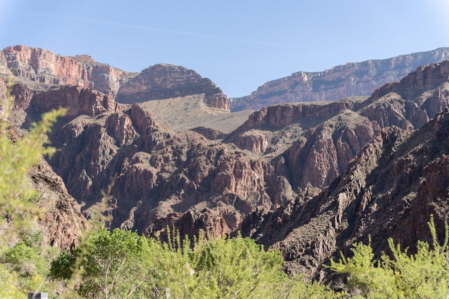 Rugged Grand Canyon cliffs under clear blue sky from South Rim