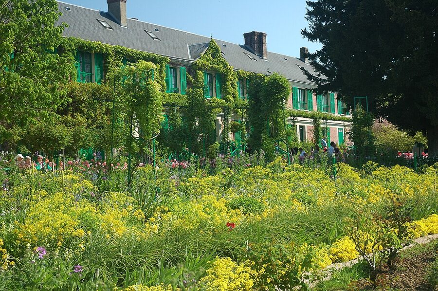 Front of Monet's house Giverny pink stucco green shutters