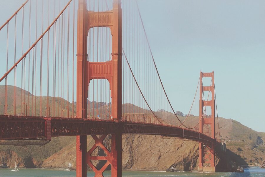 Golden Gate Bridge framed by the bay with boats and Marin hills