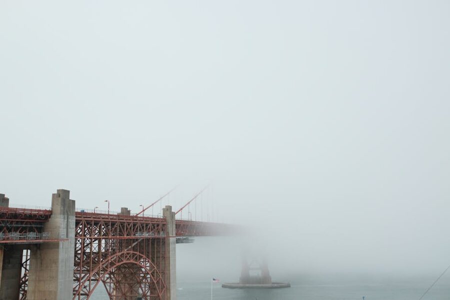 Golden Gate Bridge shrouded in dense fog over San Francisco Bay