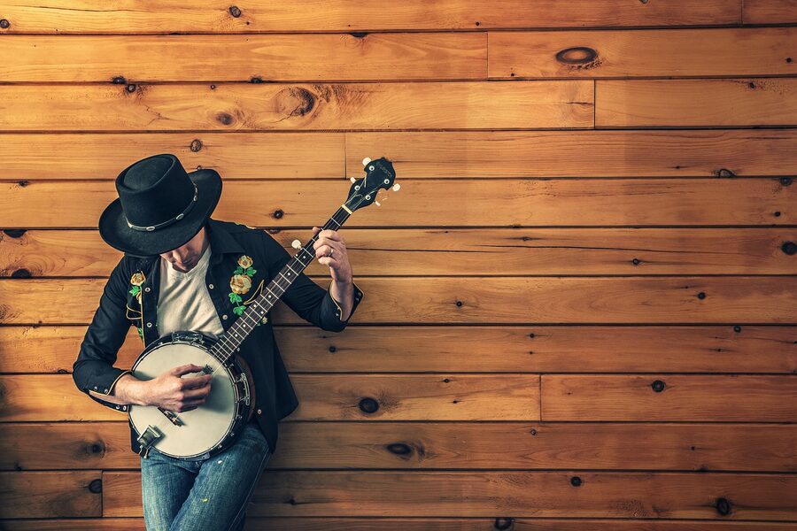 Country musician playing banjo and acoustic guitar