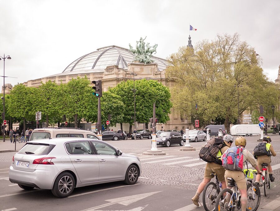 Grand Palais Paris seen from a side street with trees and traffic