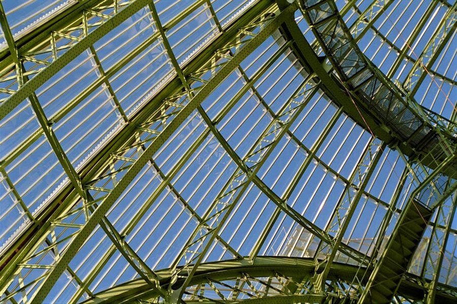 Detailed view of the Grand Palais glass roof structure from inside the nave