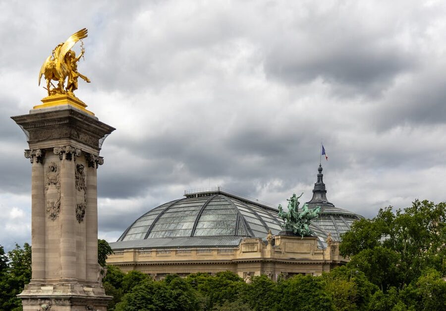 Grand Palais Paris with a golden statue and the dome under overcast Paris sky