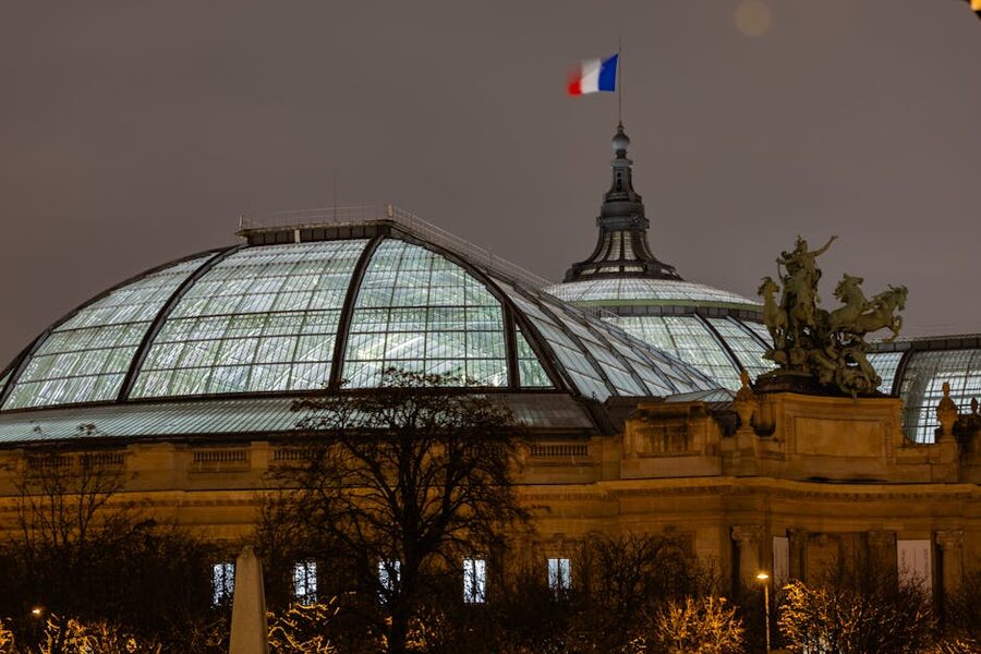 Grand Palais Paris glowing at night with the lit glass dome
