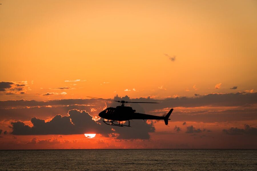 Helicopter flying over the ocean toward the Great Barrier Reef
